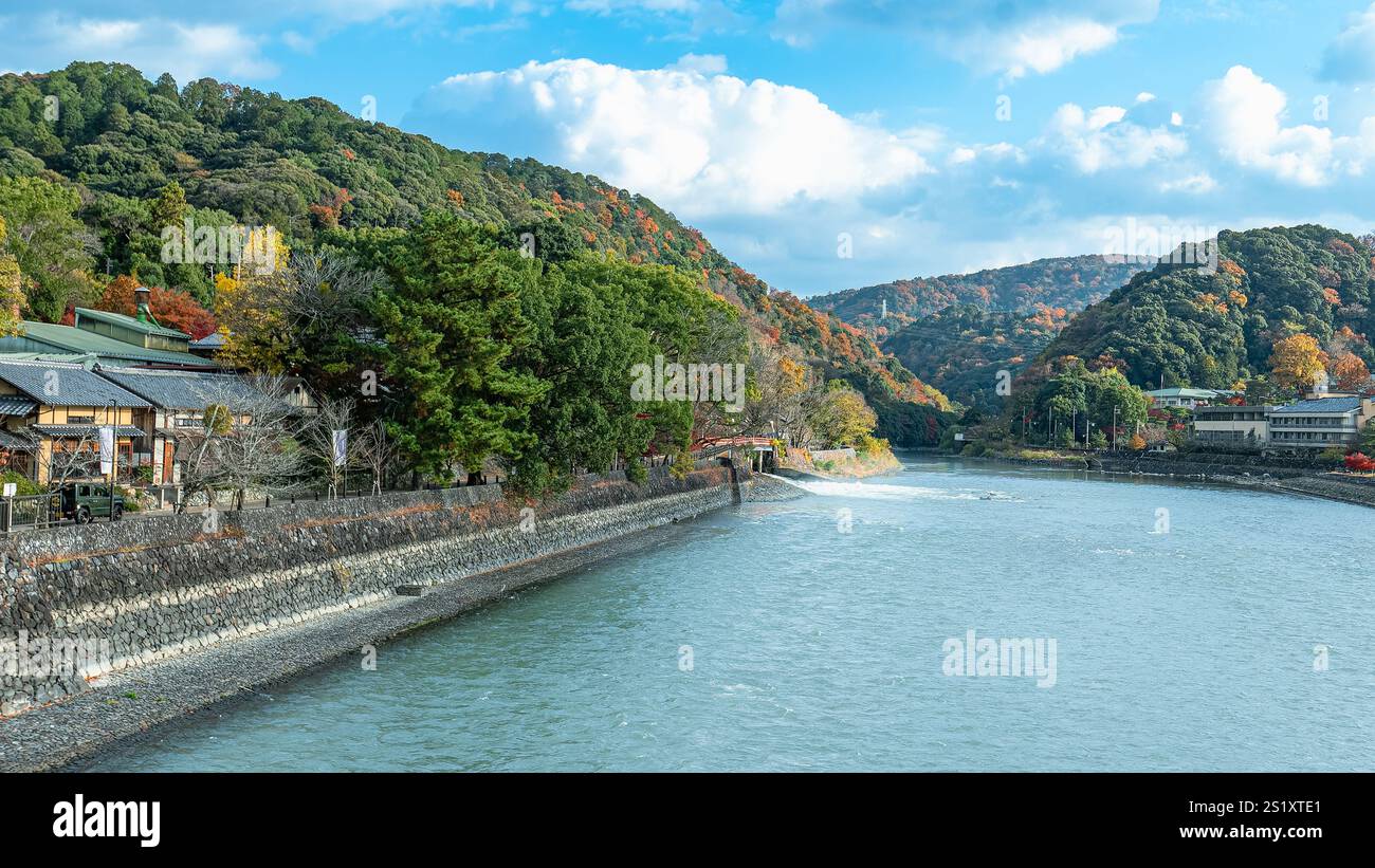A picturesque view of the Uji Riverbank with lush green trees and ...