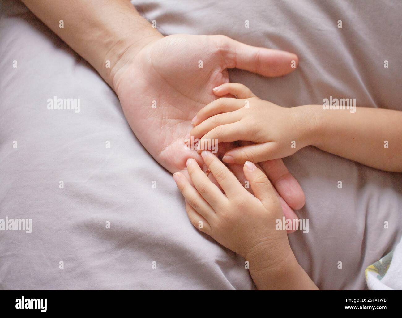 Indonesian child holding hands hi-res stock photography and images - Alamy