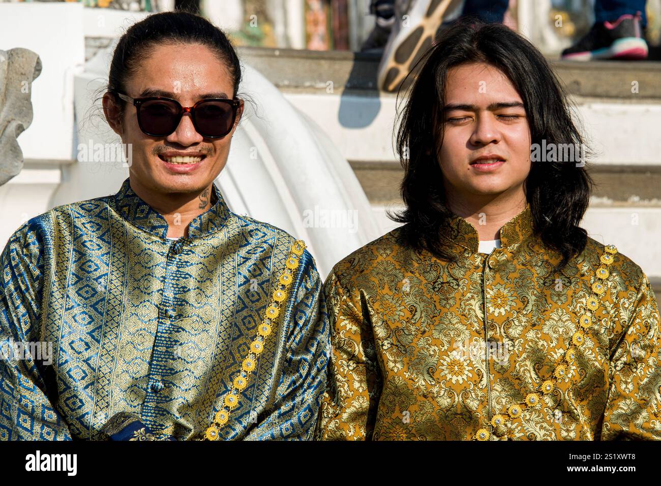 People in traditional Thai attire celebrating Makha Bucha Day at Wat Arun, showcasing cultural ...