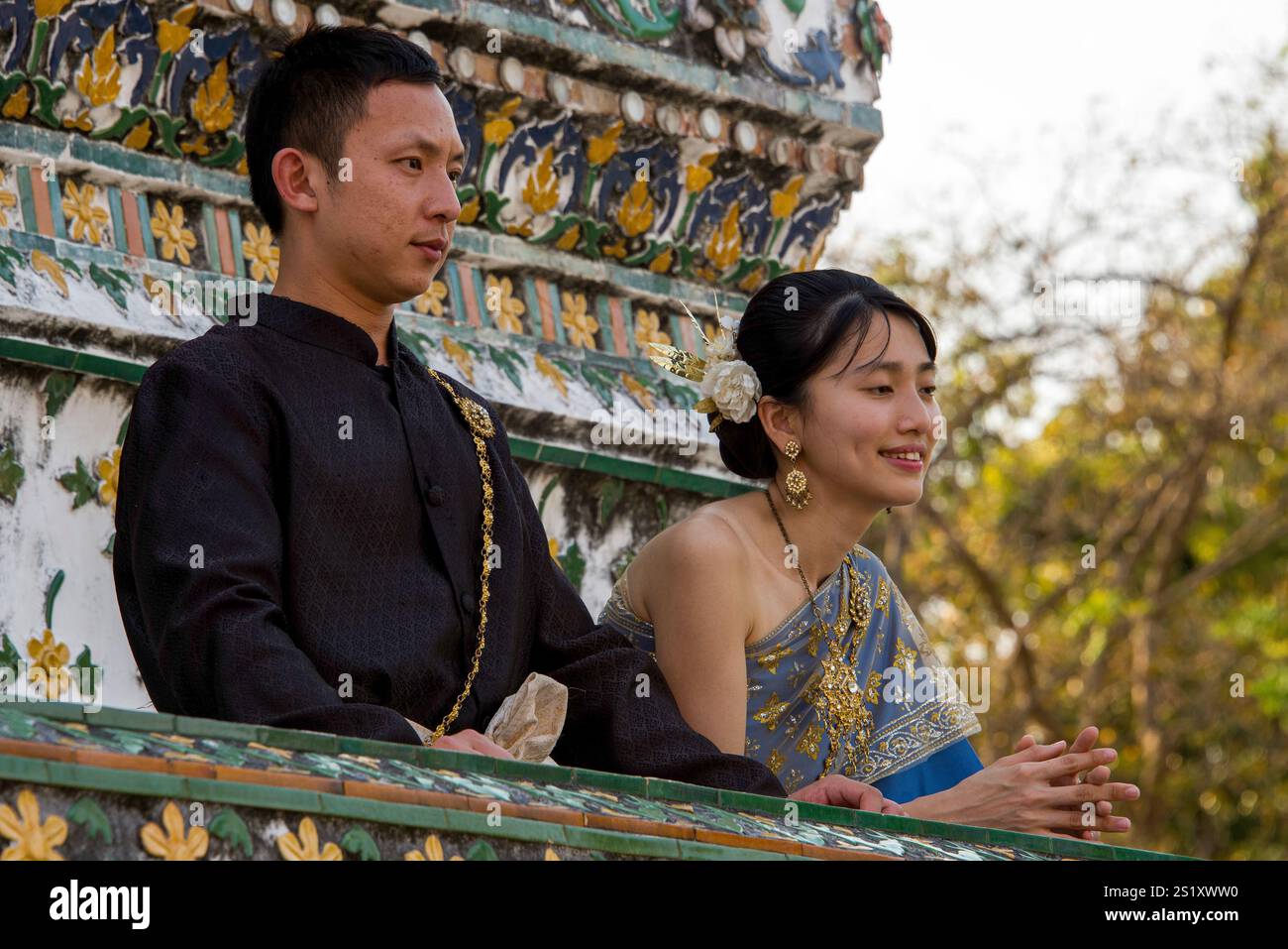 People in traditional Thai attire celebrating Makha Bucha Day at Wat Arun, showcasing cultural ...