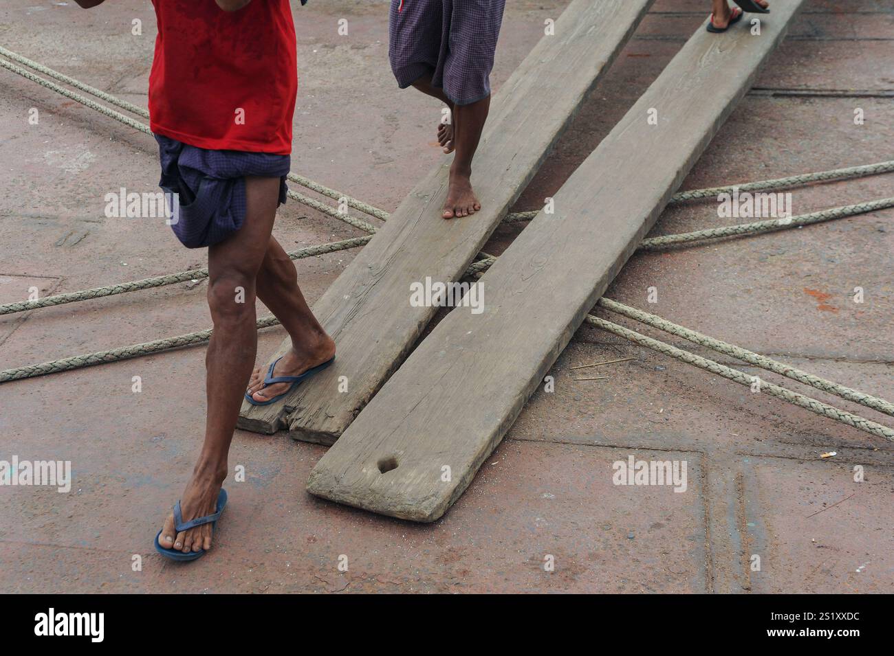 11.11.2015, Yangon, Myanmar, Asia - Men walk barefoot and wearing flip ...