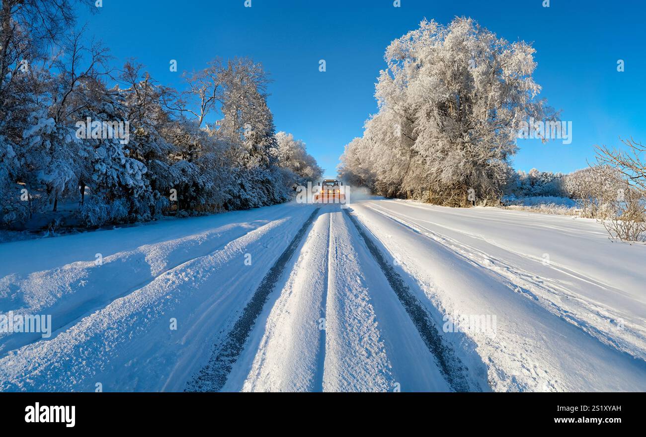 Snowplough clearing snow from a main road in southwest Scotland Stock ...