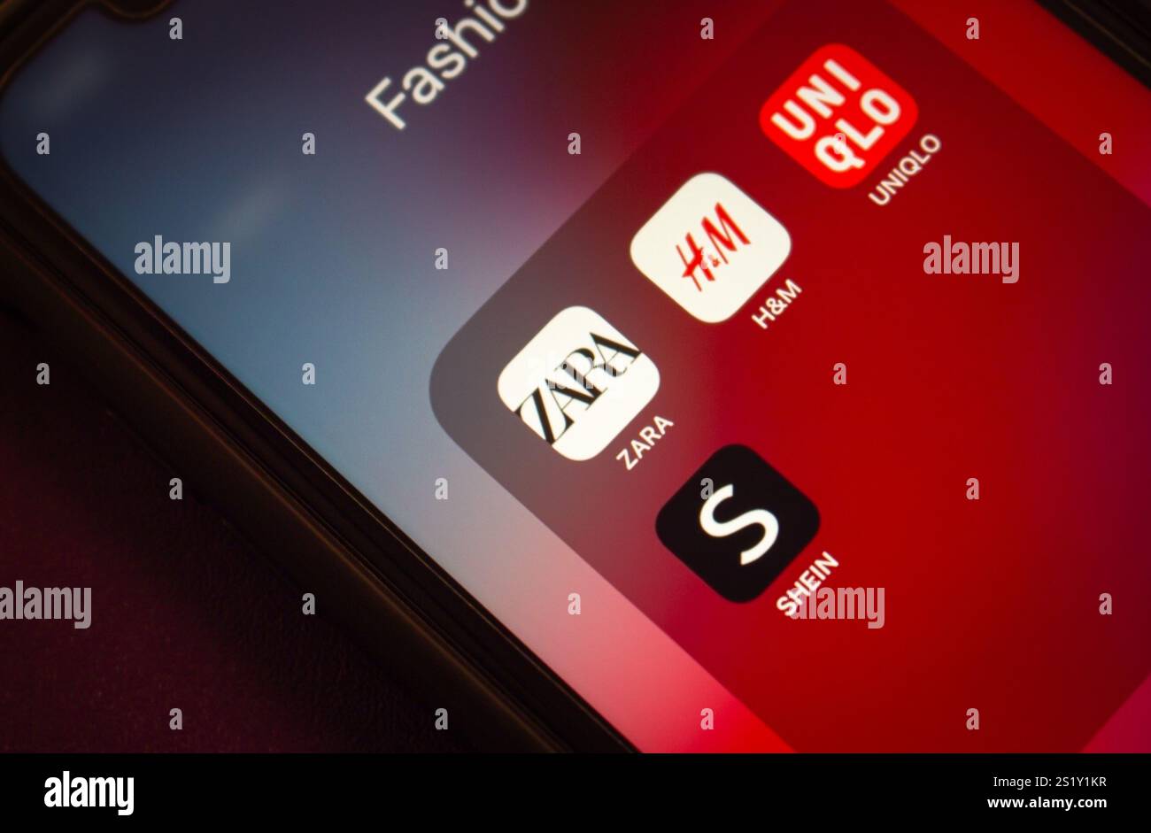 Smartphone screen showing popular fashion retail apps Zara, H&M, Uniqlo, and Shein, representing ...