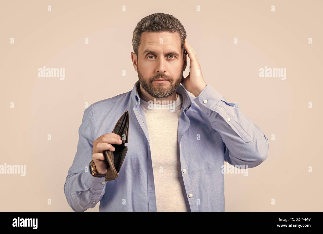 amazed poor man with wallet isolated on studio background. poor man ...