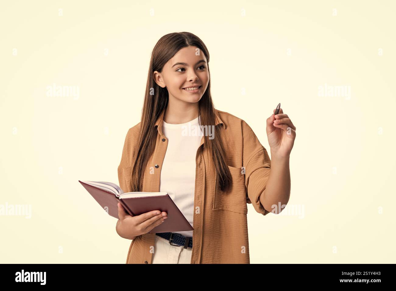 positive teen girl noting school diary book. photo of teen girl noting ...