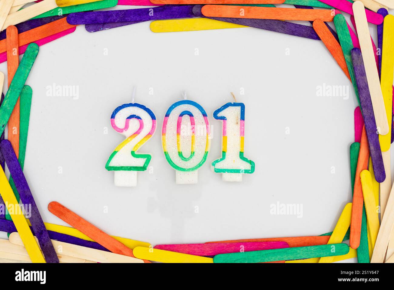 Candles in shape of the number 201 in popsicle colorful sticks frame ...