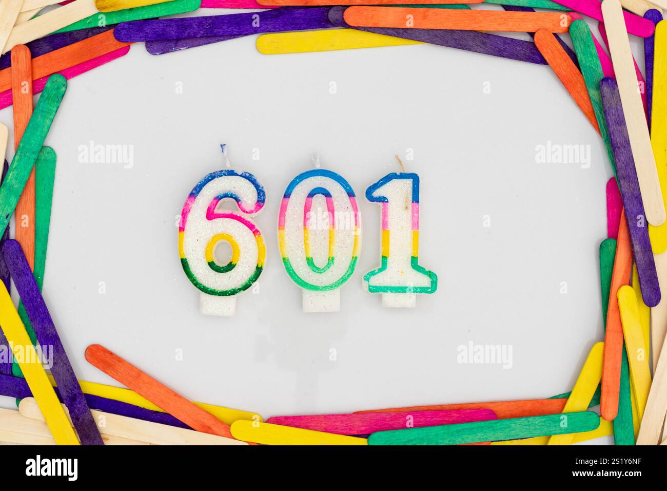 Candles in shape of the number 601 in popsicle colorful sticks frame ...