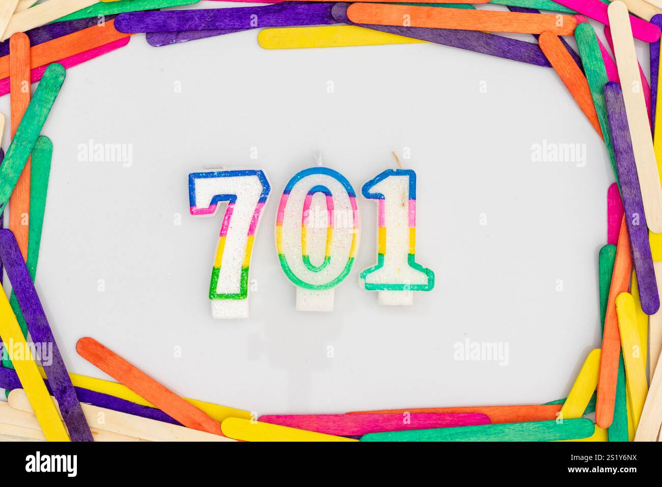 Candles in shape of the number 701 in popsicle colorful sticks frame ...