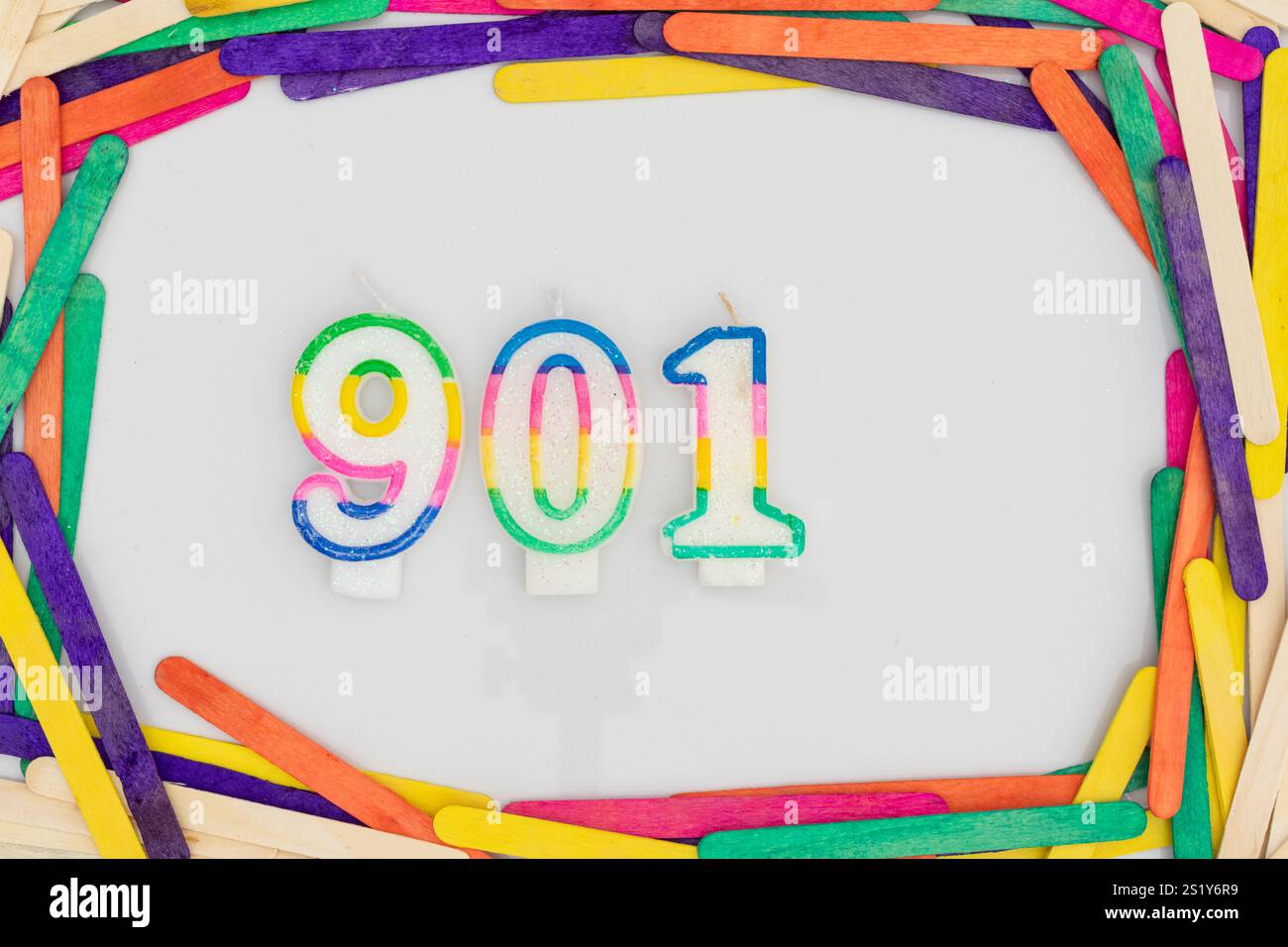 Candles in shape of the number 901 in popsicle colorful sticks frame ...