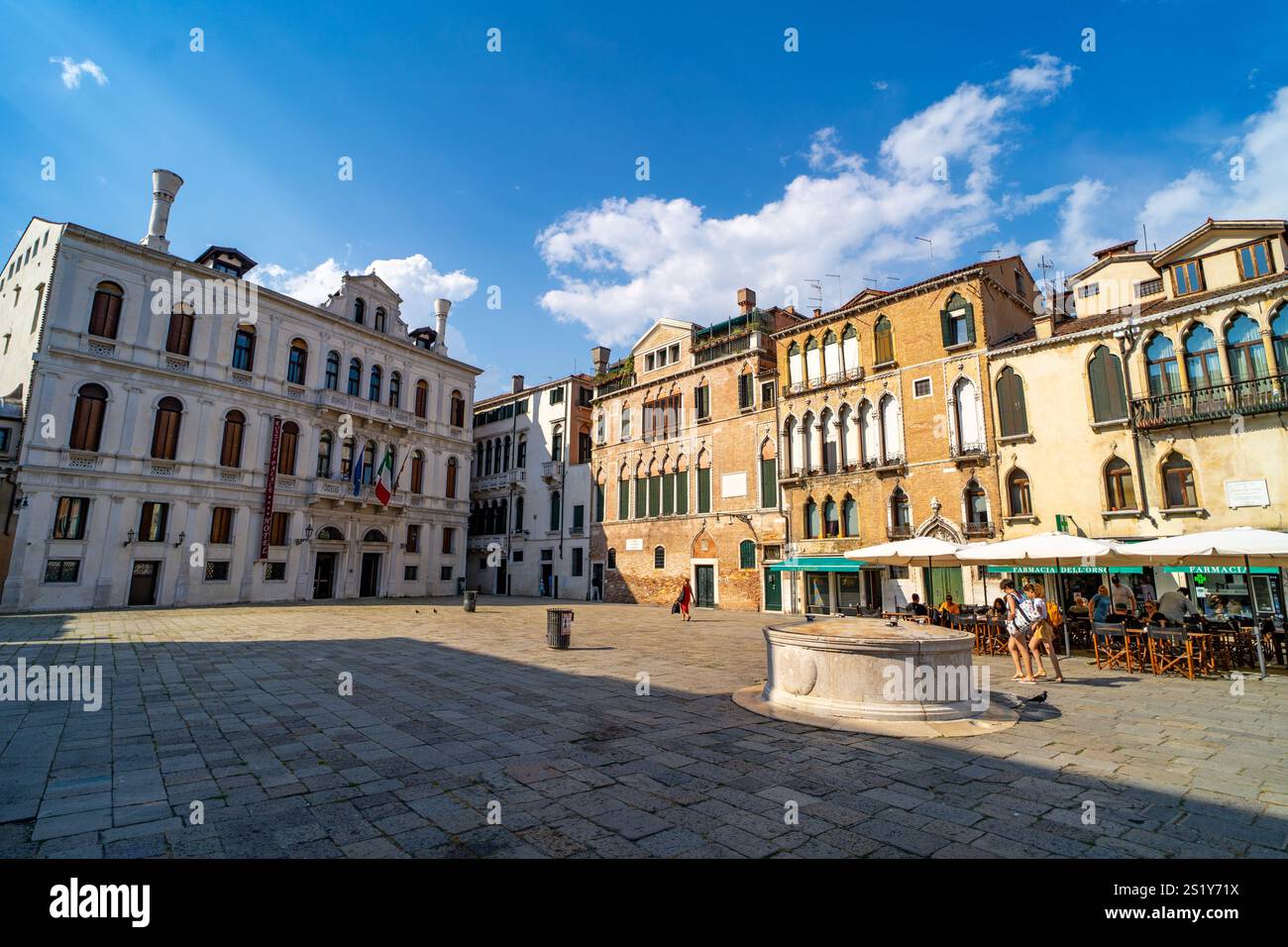 A charming Venetian square surrounded by historic buildings with ornate ...