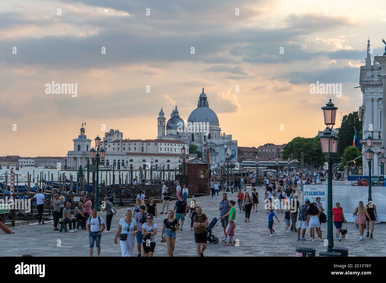 Evening view of a busy waterfront promenade in Venice, Italy, with ...