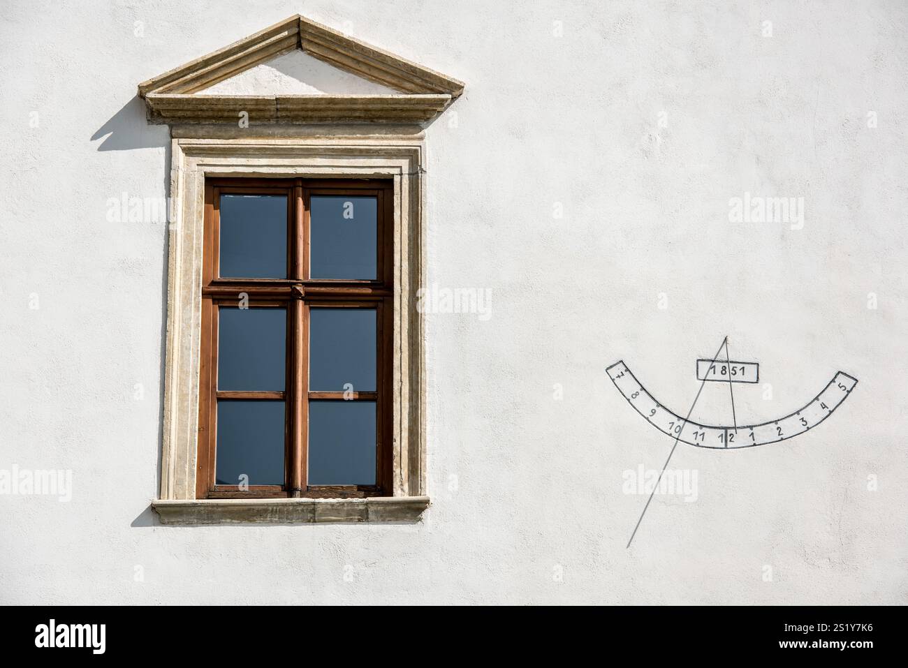 Sundial on a Stone Wall with Ancient Windows Stock Photo - Alamy