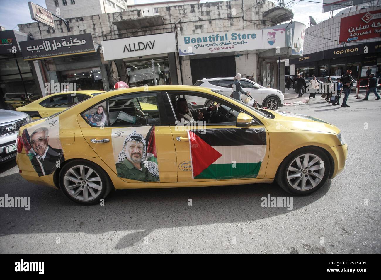 A view of a transport vehicle carrying pictures of the late President ...