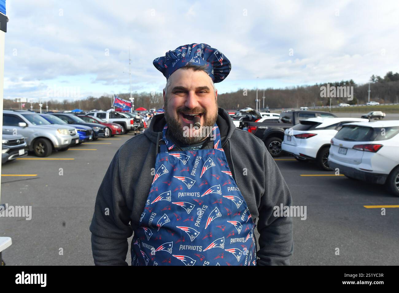 Adam Hirsch, of Wayland, Mass. enjoys a cigar while tailgating prior to ...