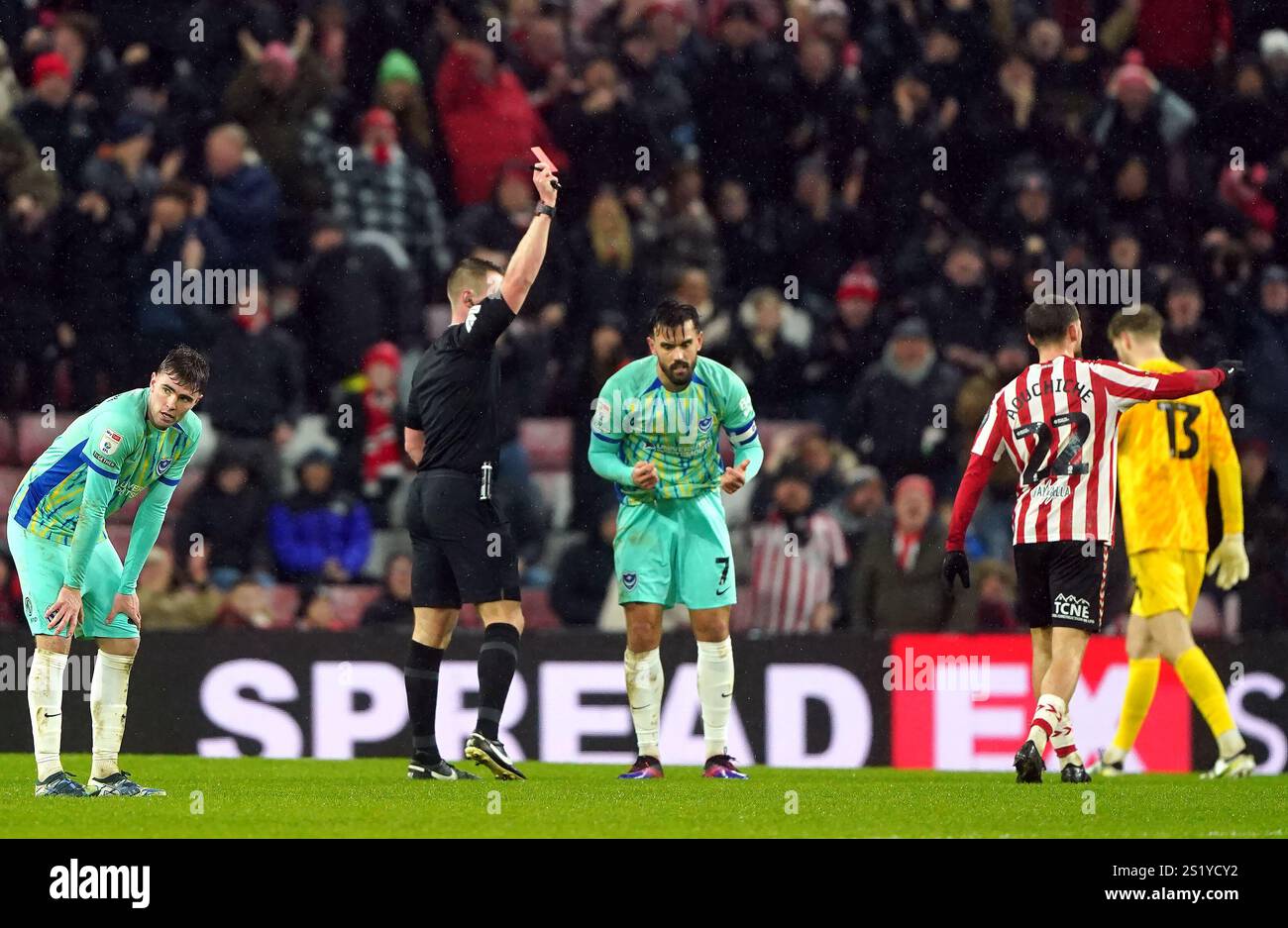 Referee Thomas Bramall shows a red card to Portsmouth's Marlon Pack ...