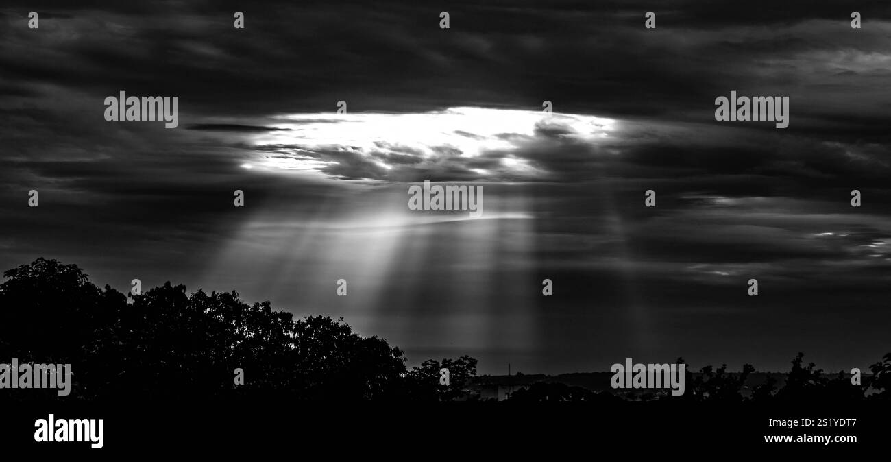 Dramatic sky with rays of light coming out of the clouds Stock Photo ...