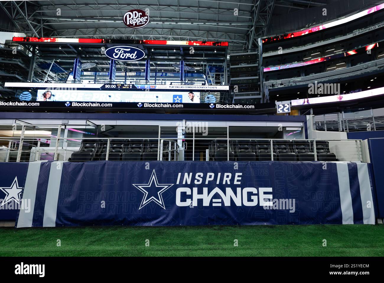 A wall sign / banner at AT&T Stadium shows the NFL's "Inspire Change ...