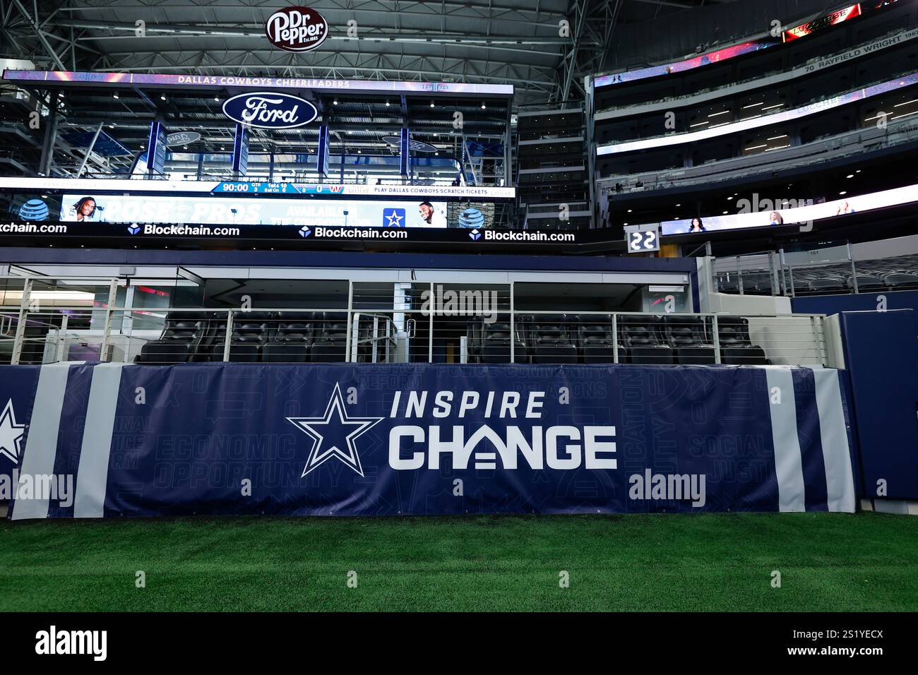A wall sign / banner at AT&T Stadium shows the NFL's "Inspire Change ...