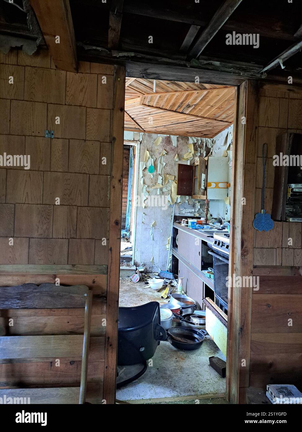 Door to kitchen from living room inside abandoned dilapidated cabin in ...