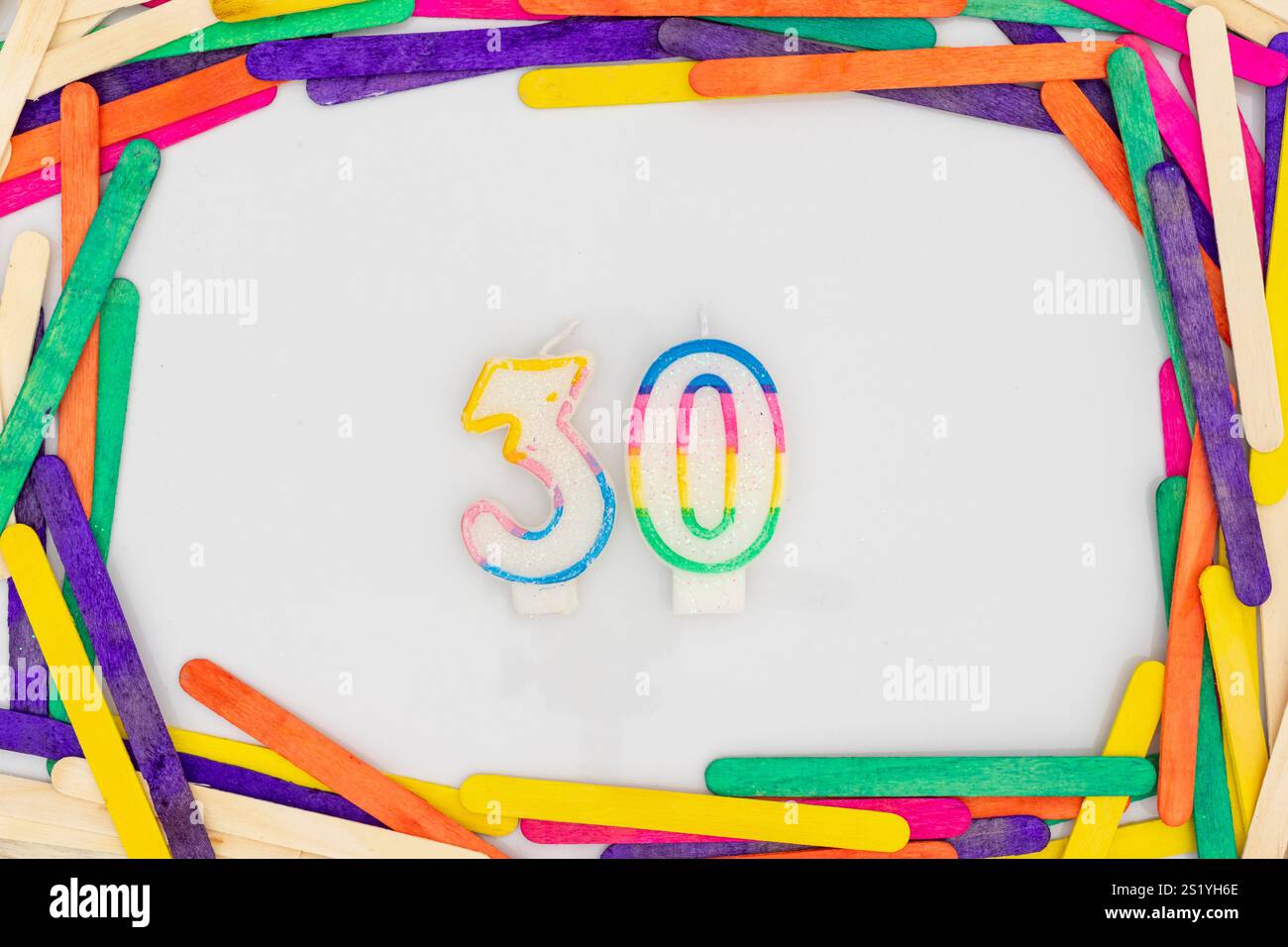 Number 30 shape birthday candles in a colorful popsicle sticks frame ...