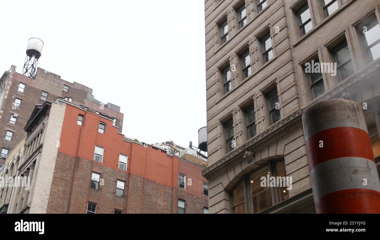 Steam vapor vented on New York City street, orange vapour tube stack ...