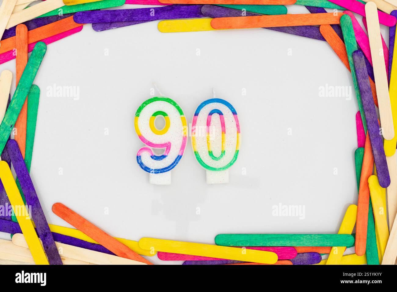 Number 90 shape birthday candles in a colorful popsicle sticks frame ...