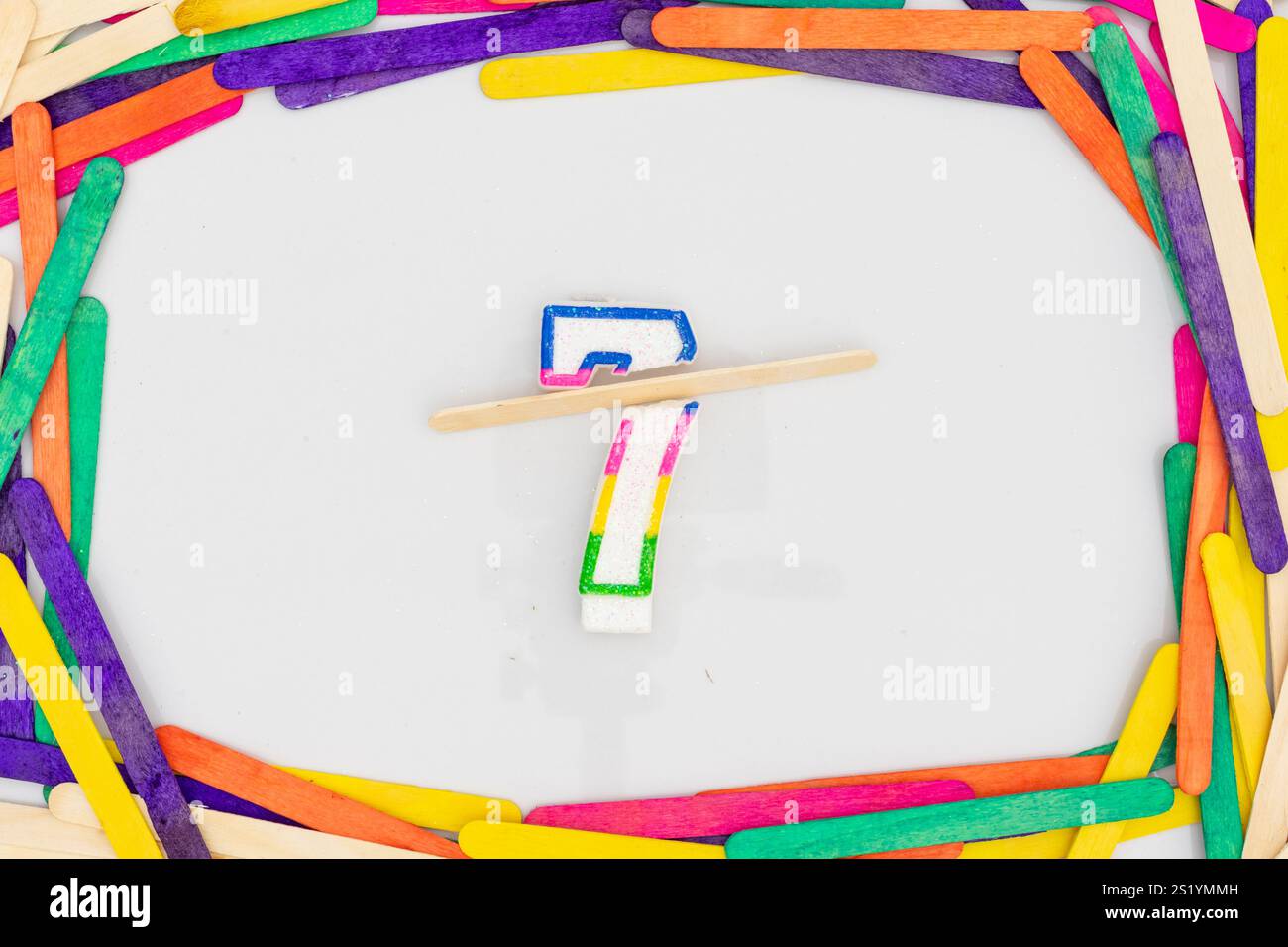 Seven numerical number shape rainbow colors candle cut in two pieces ...