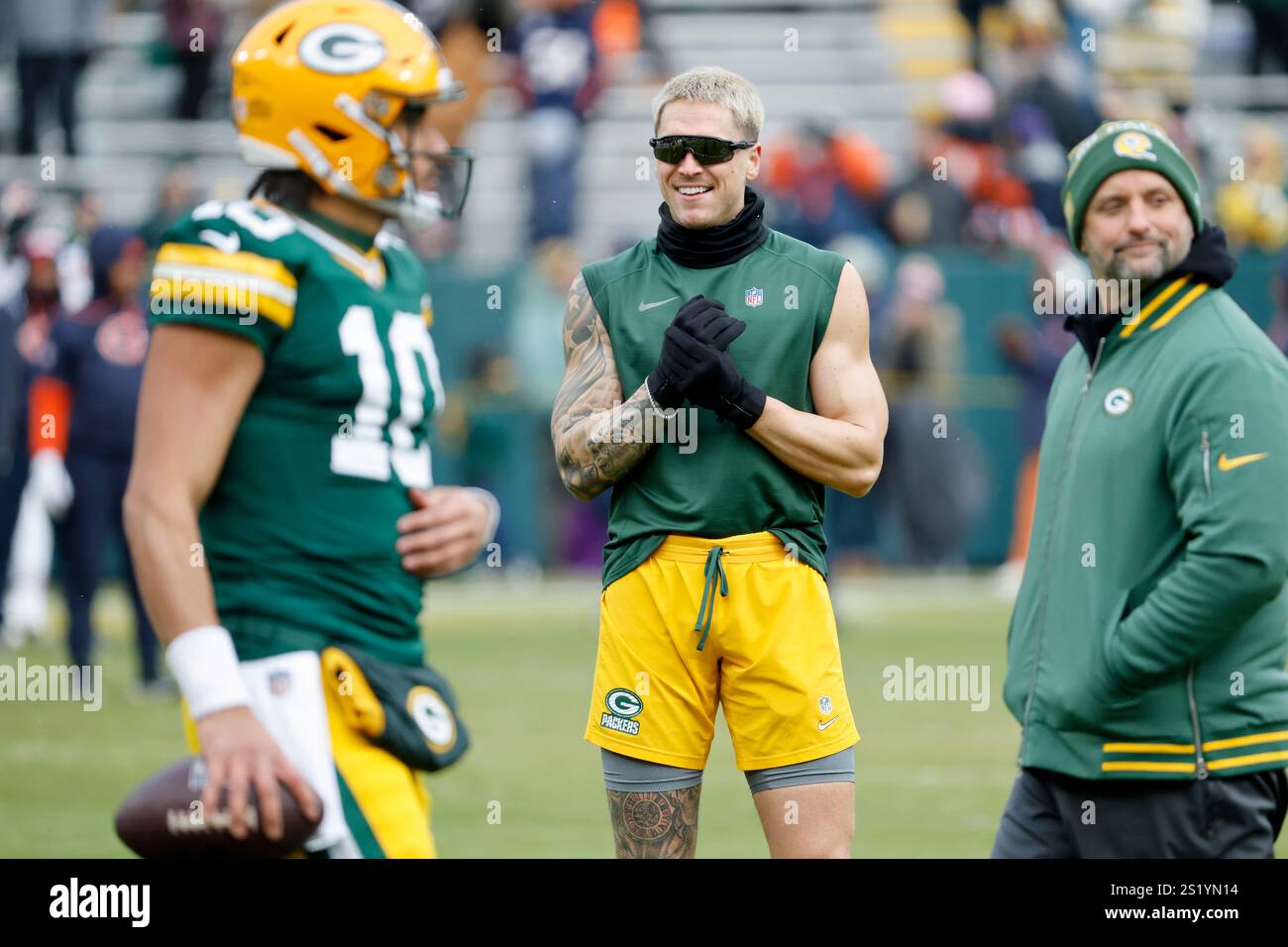Green Bay Packers' Alex McGough, middle, watches players warm up before ...