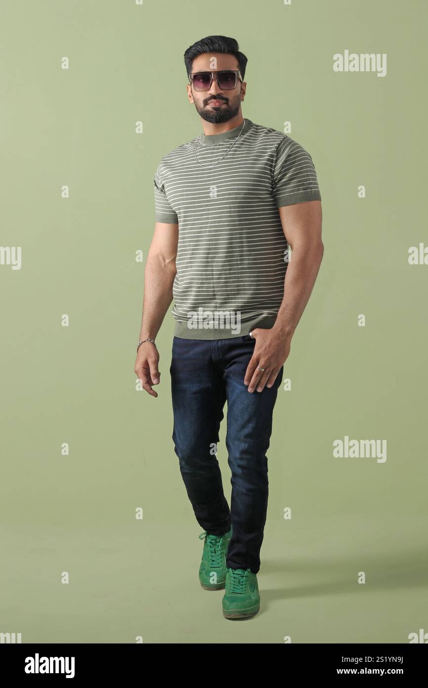 portrait of a young handsome pakistani male model with glasses against ...