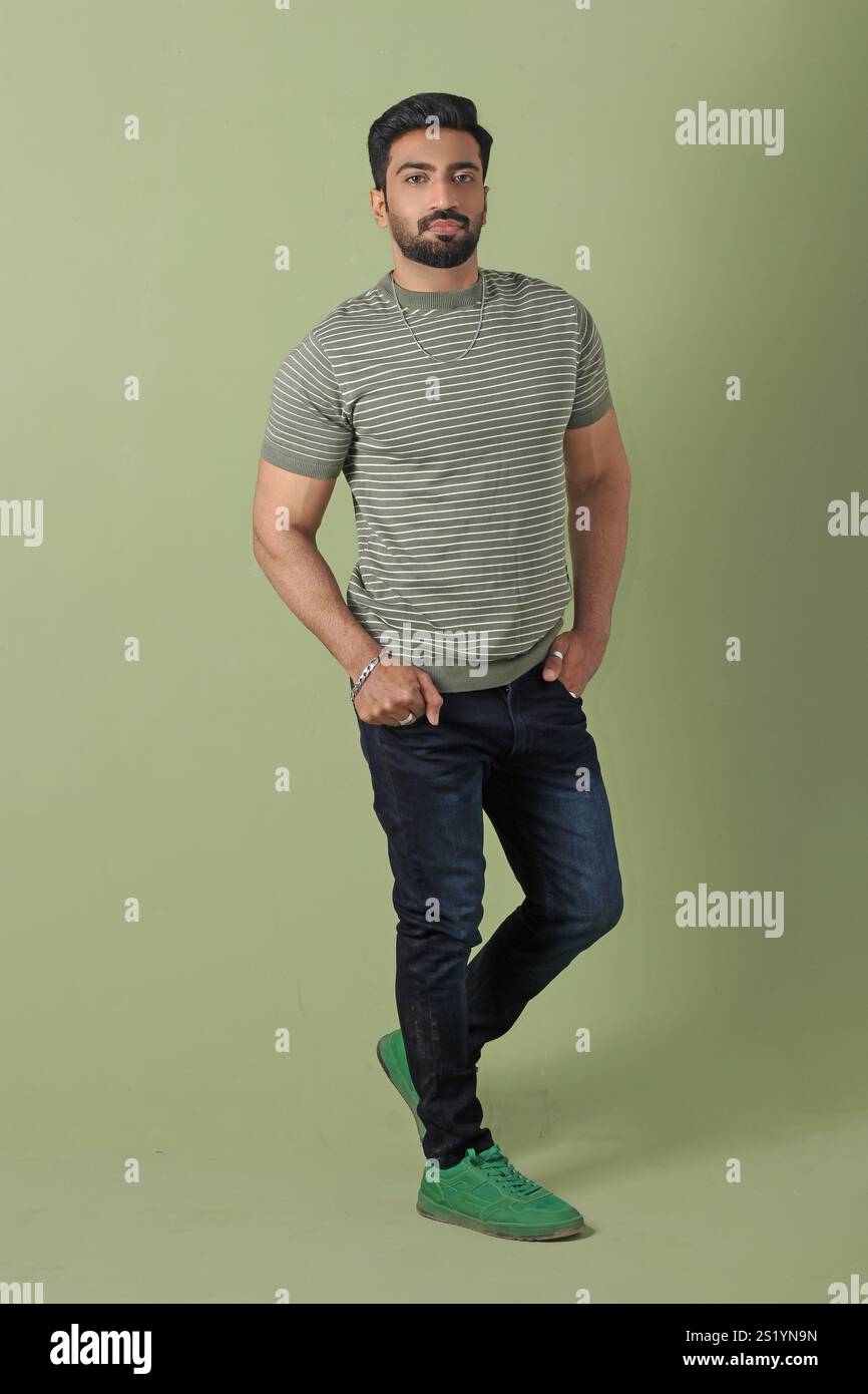 portrait of a young handsome pakistani male model with glasses against ...