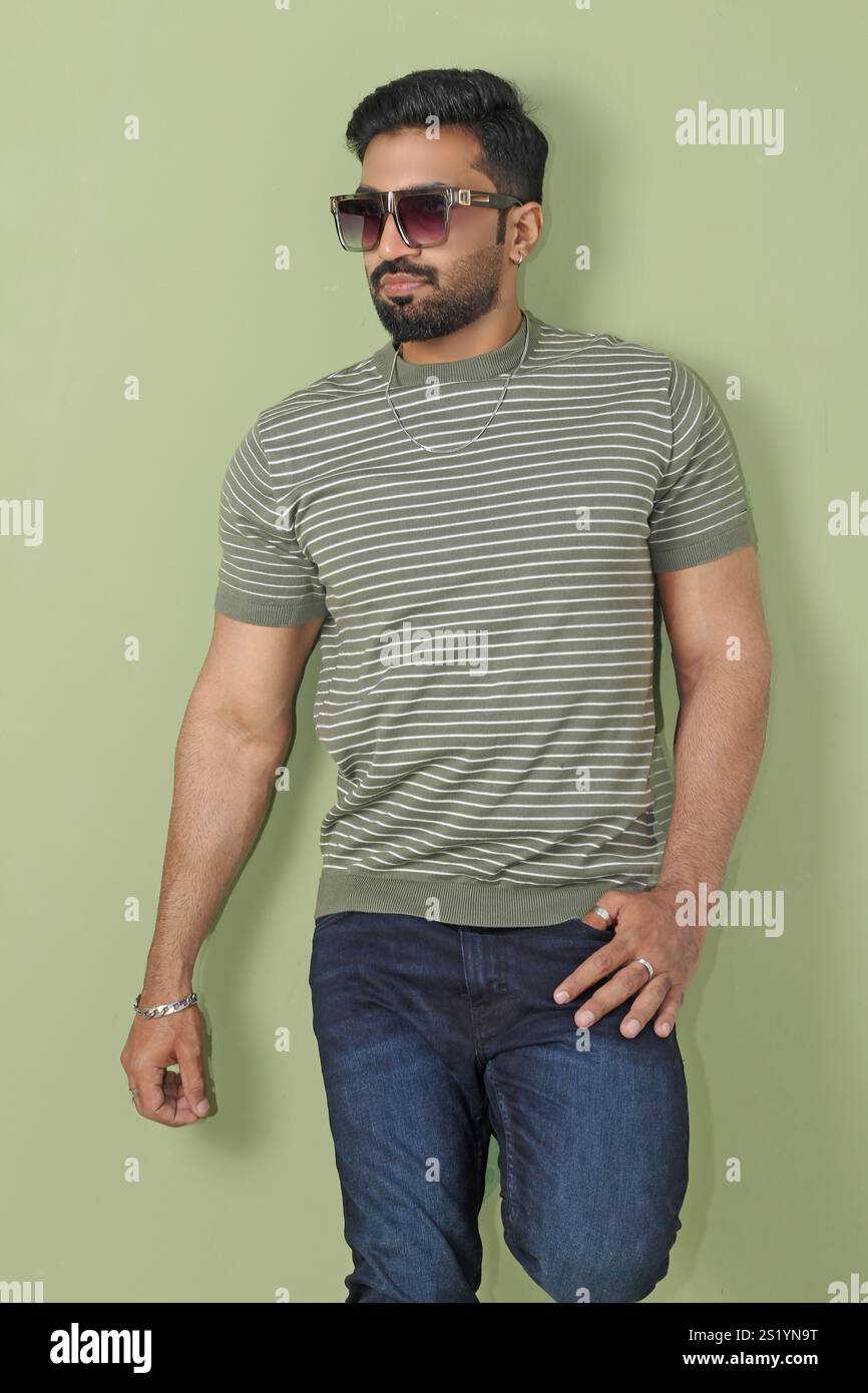 portrait of a young handsome pakistani male model with glasses against ...