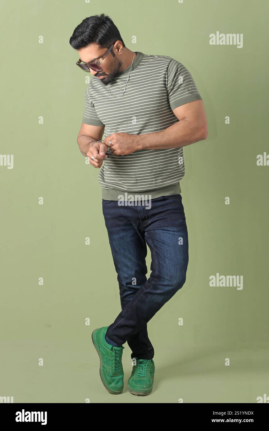 portrait of a young handsome pakistani male model with glasses against ...