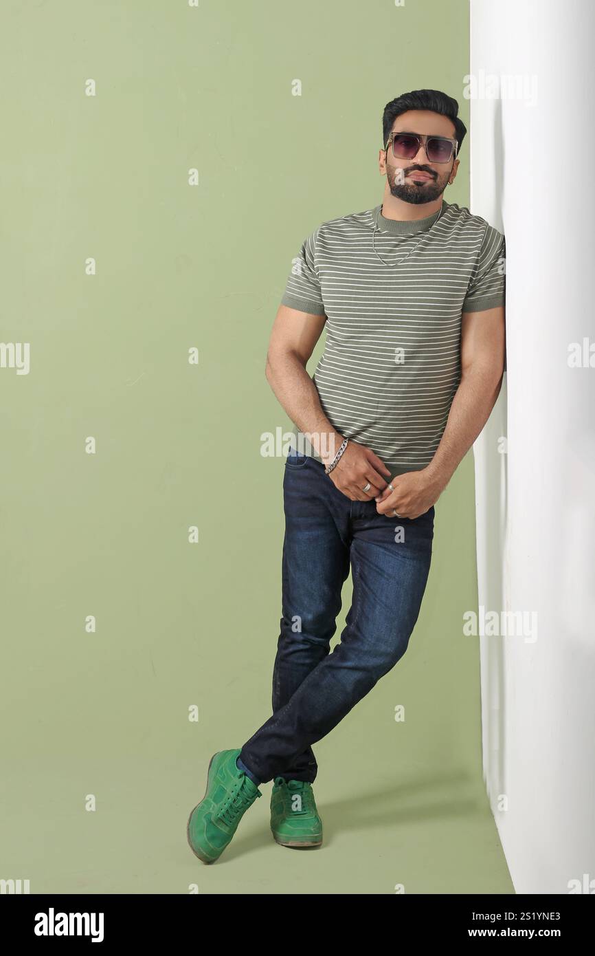 portrait of a young handsome pakistani male model with glasses against ...