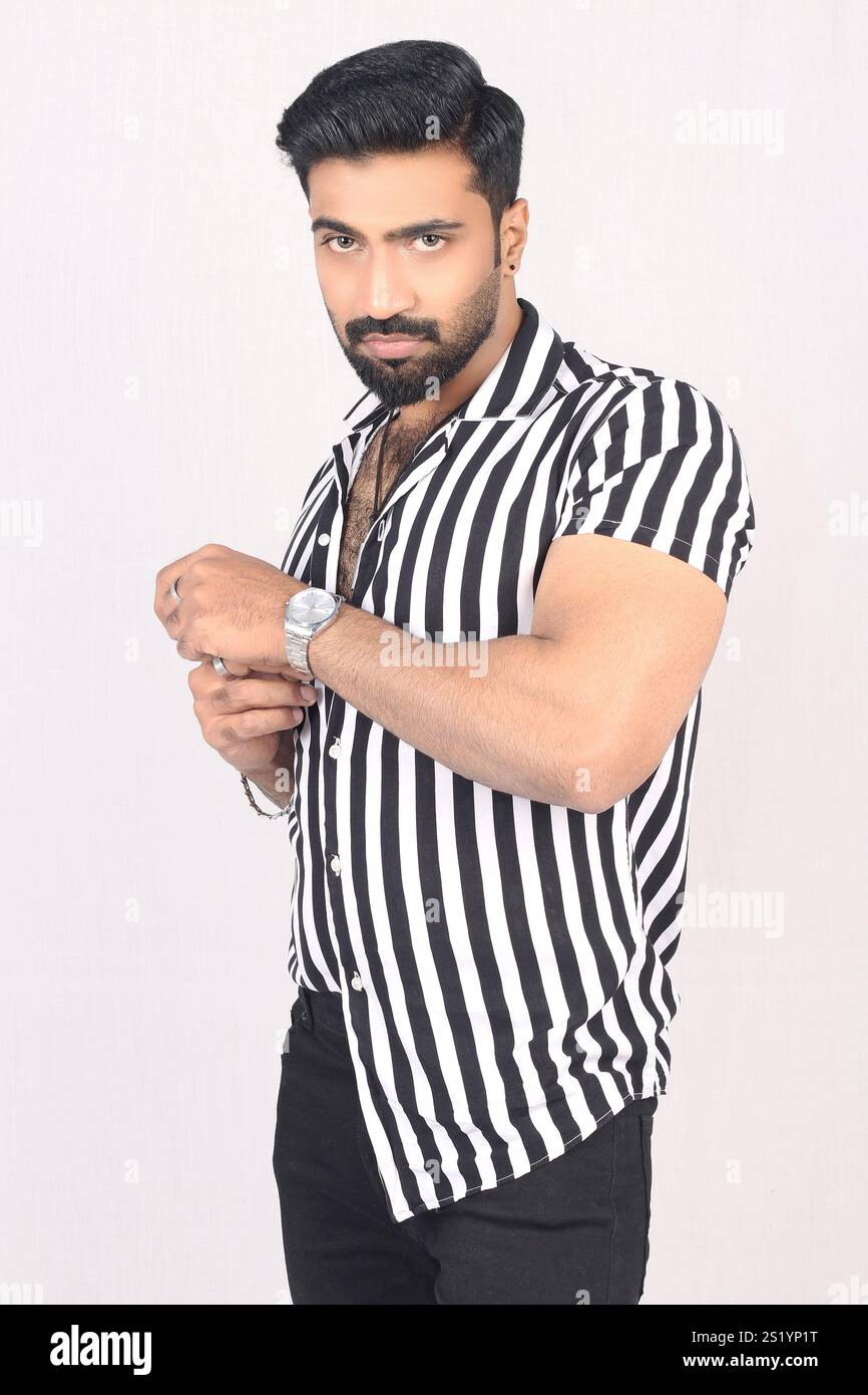Portrait of an indian young male model in stripe shirt resemble in ...