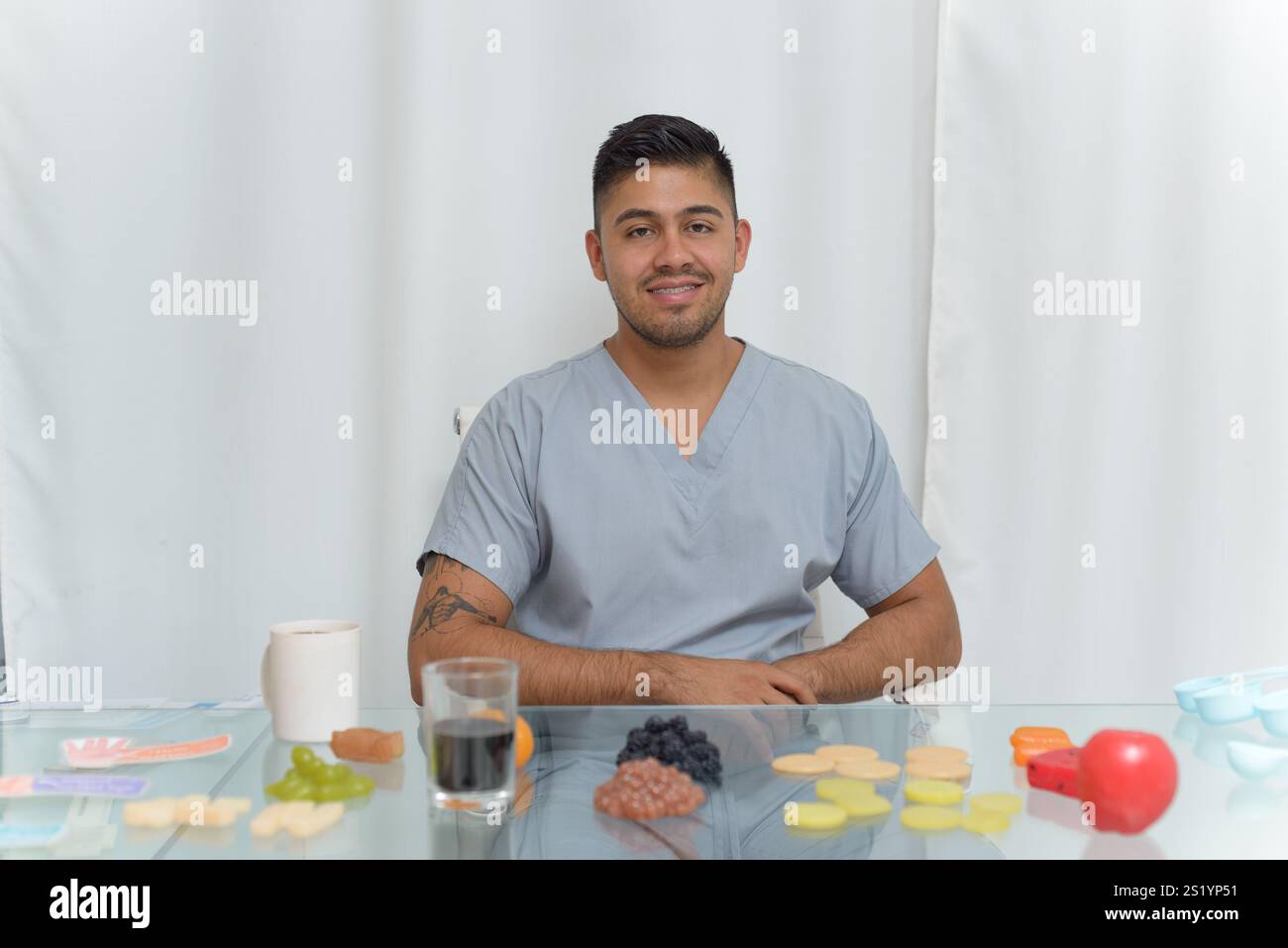 A nutritionist sitting in her office in front of a table with food ...