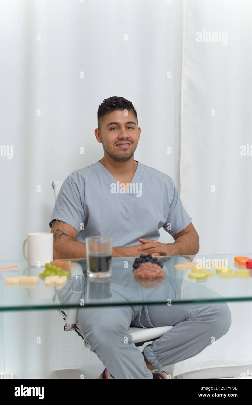 A nutritionist sitting in her office in front of a table with food ...