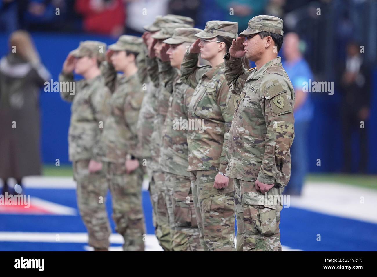 Member of the military salute during the National Anthem before an NFL ...