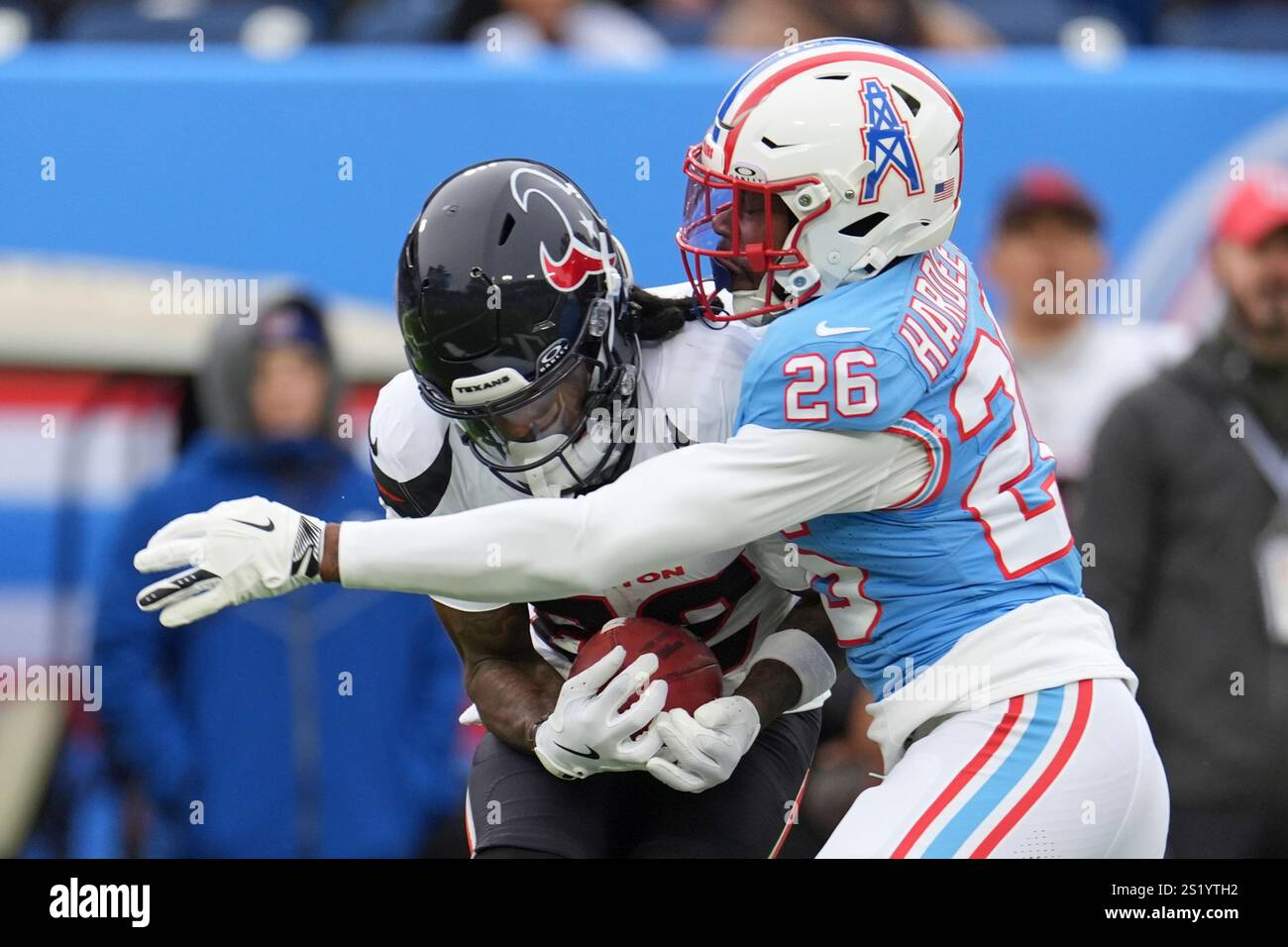 Houston Texans' Diontae Johnson, left, is tackled by Tennessee Titans ...