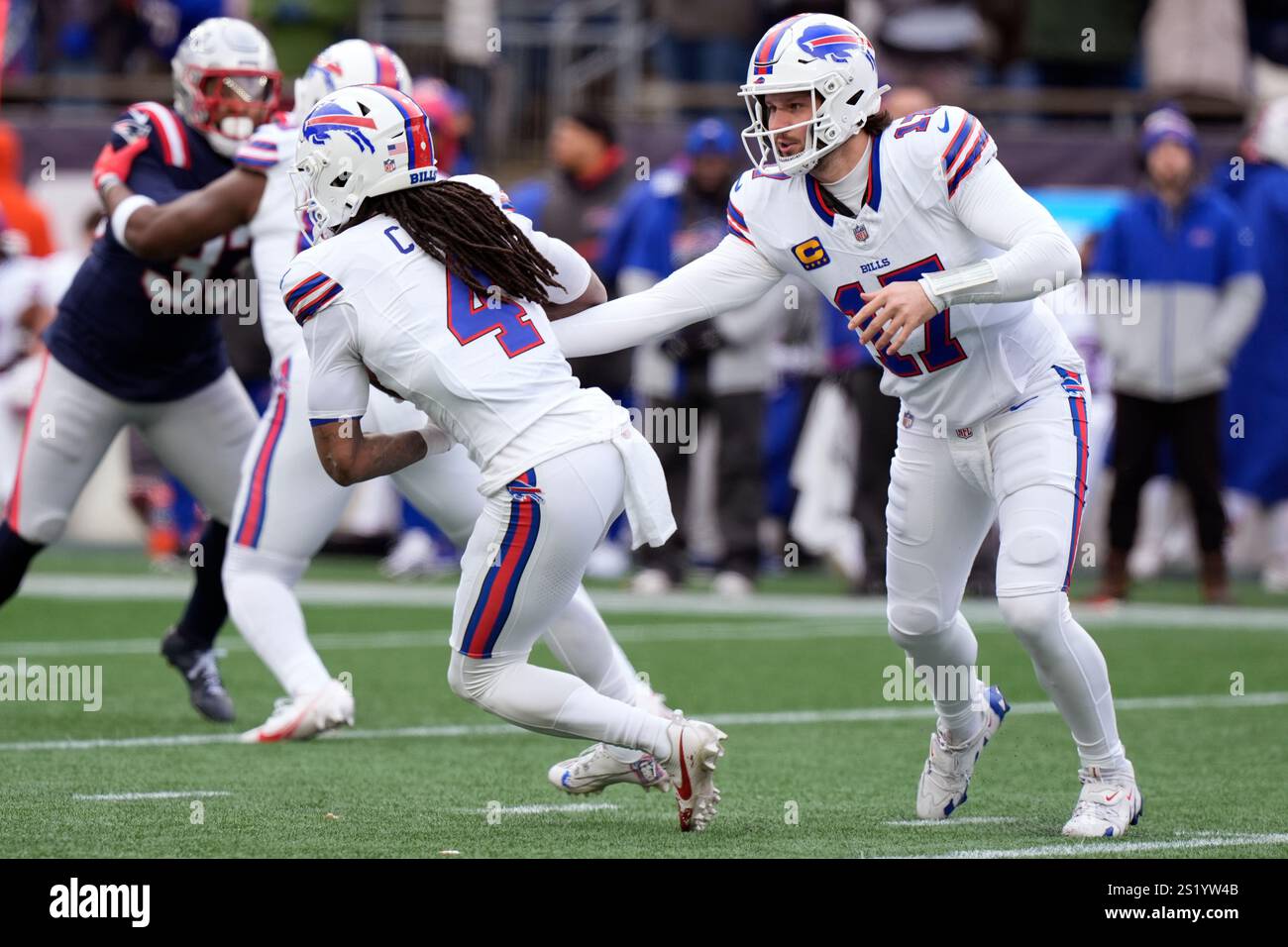 Buffalo Bills quarterback Josh Allen (17) hands off to running back ...
