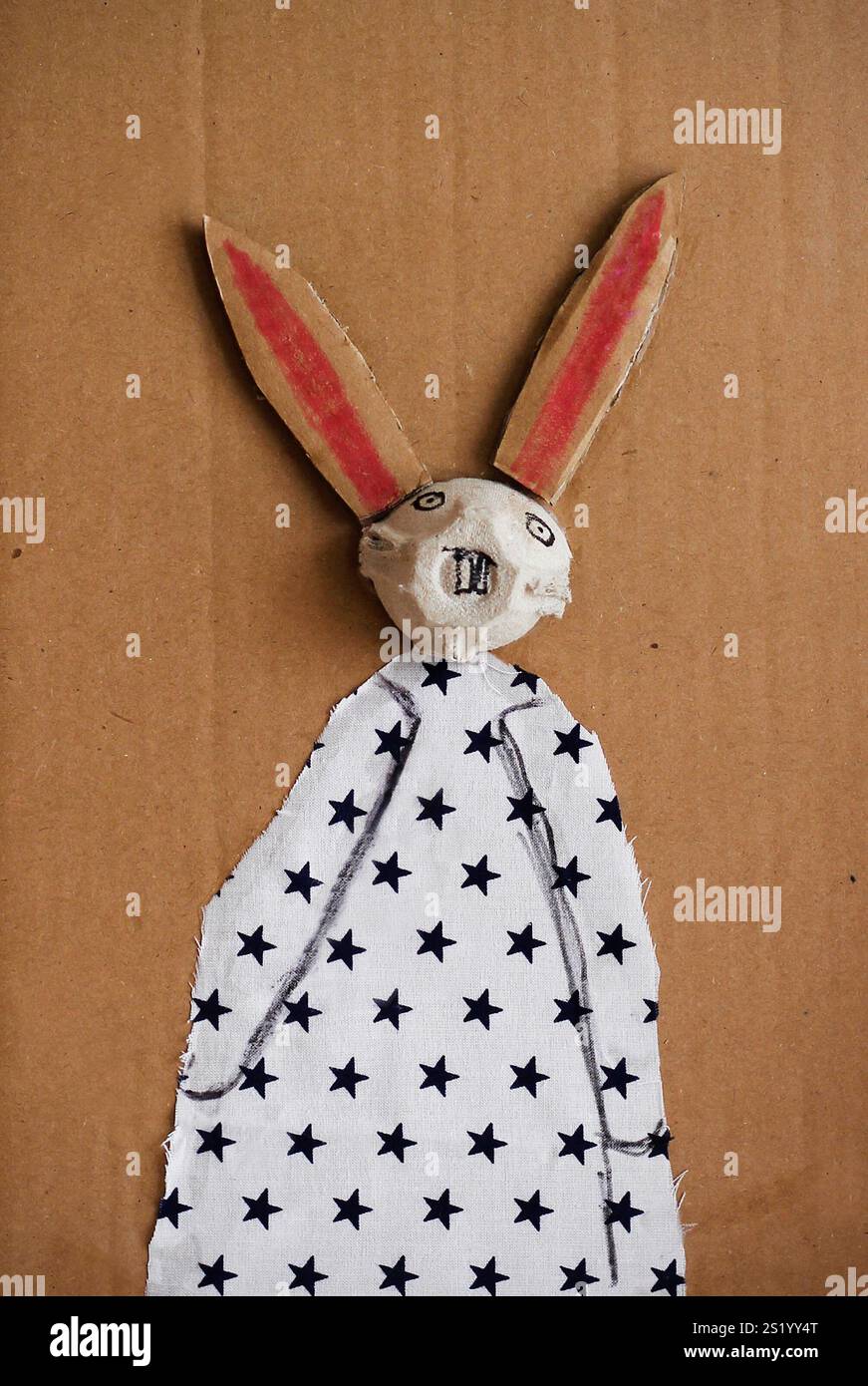 Easter rabbit made by a child from egg packaging, carton and a piece of ...