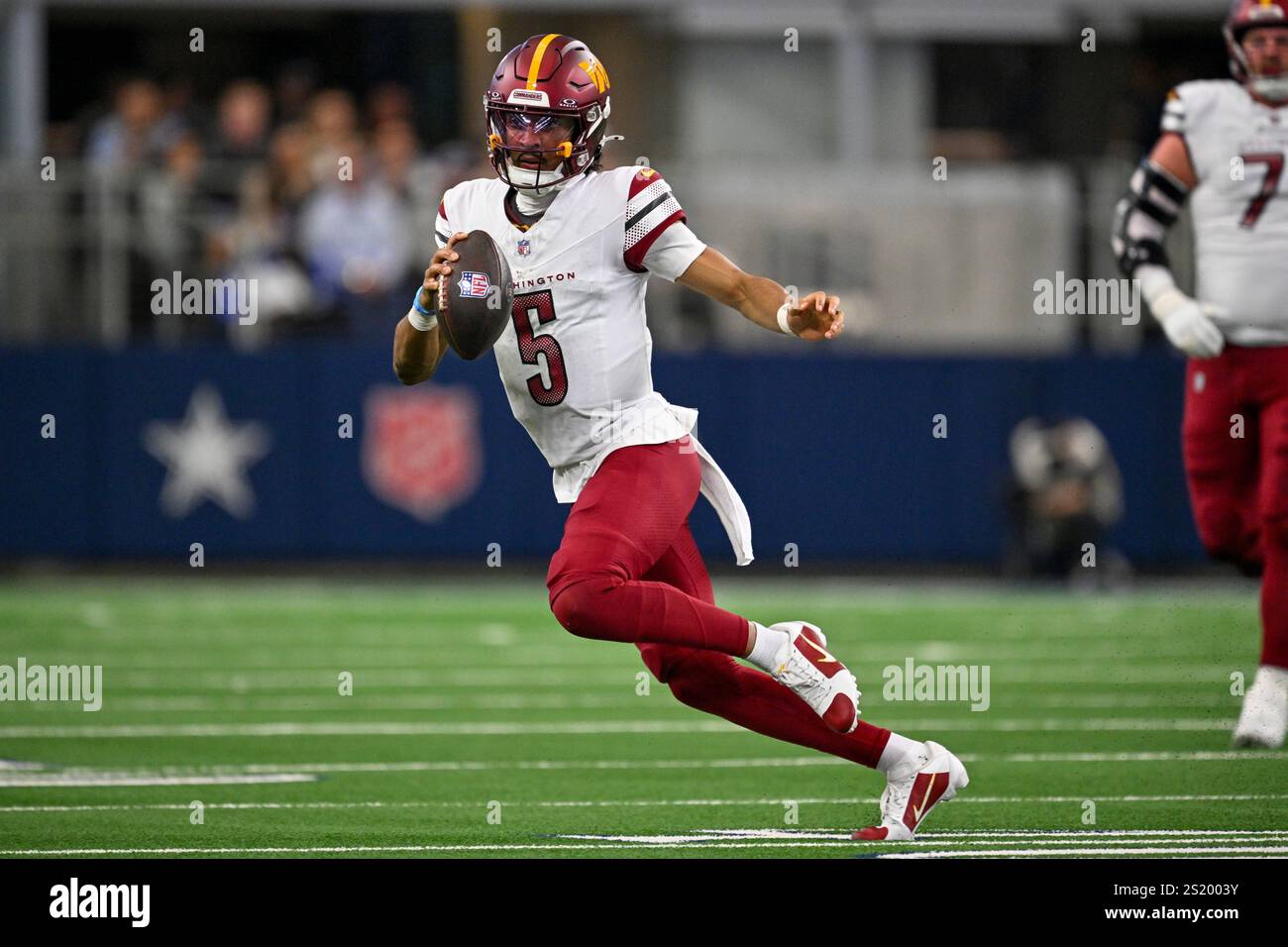 Washington Commanders quarterback Jayden Daniels runs with the ball ...