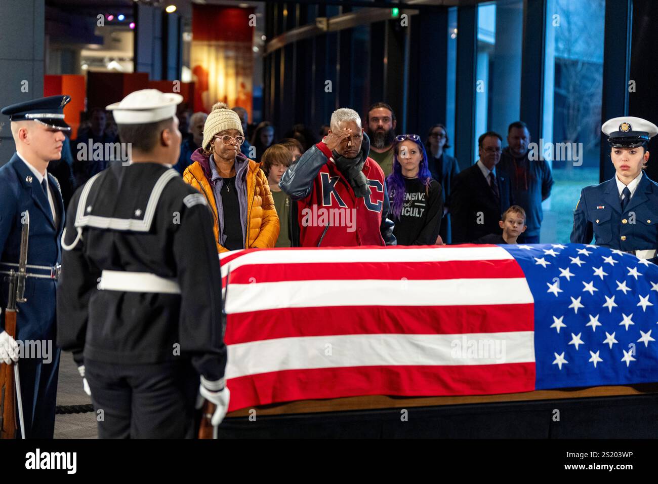 Mourners view the casket of former President Jimmy Carter as he lies in ...