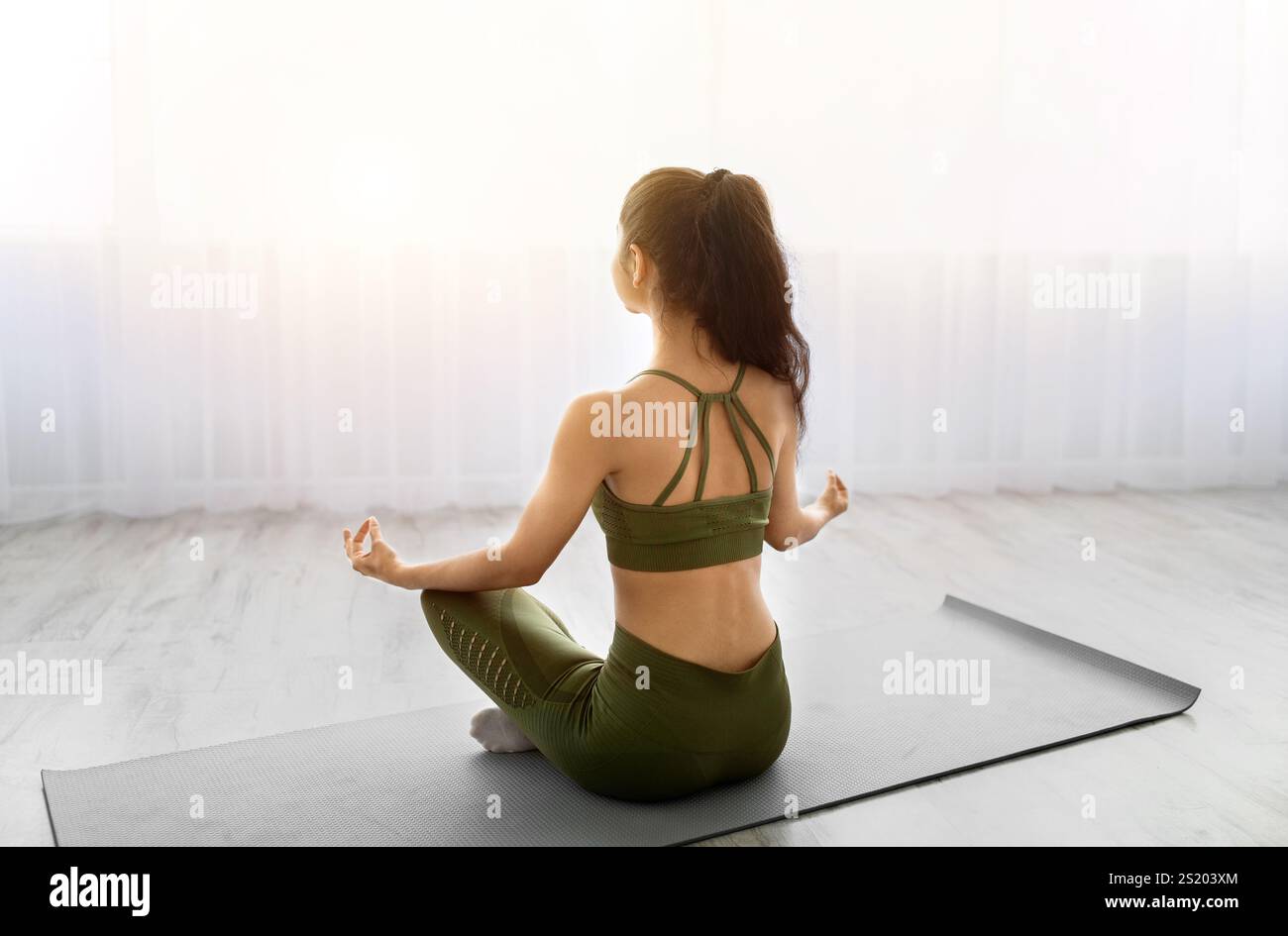 Back view of peaceful Indian woman sitting in lotus pose, meditating ...