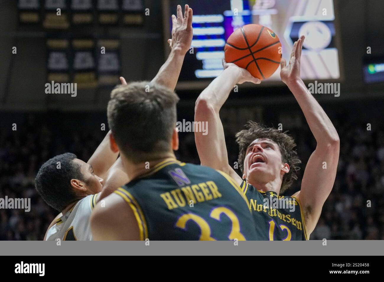 Northwestern guard Brooks Barnhizer shoots over Purdue forward Trey ...