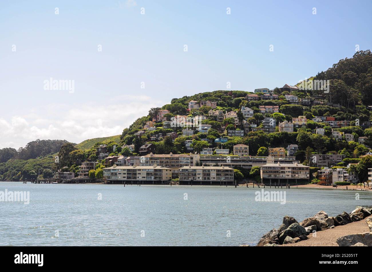 Charming hillside view of Sausalito waterfront homes under bright sky ...