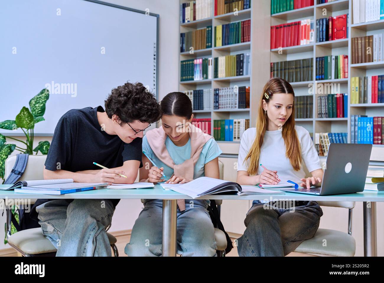 Group of high school students studying in library classroom Stock Photo ...