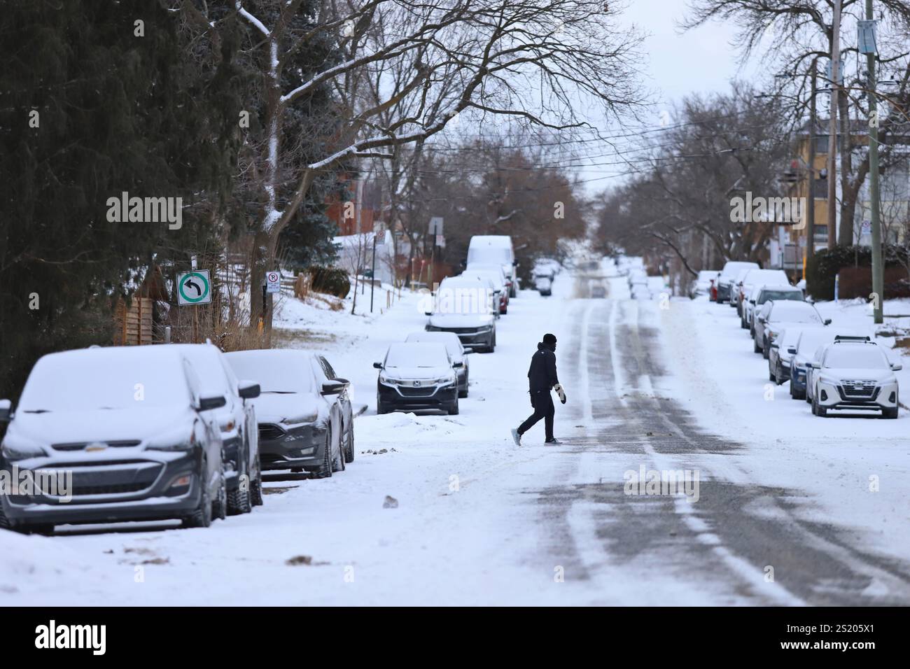 A person walks in the middle of a snowstorm in the city of Montreal ...