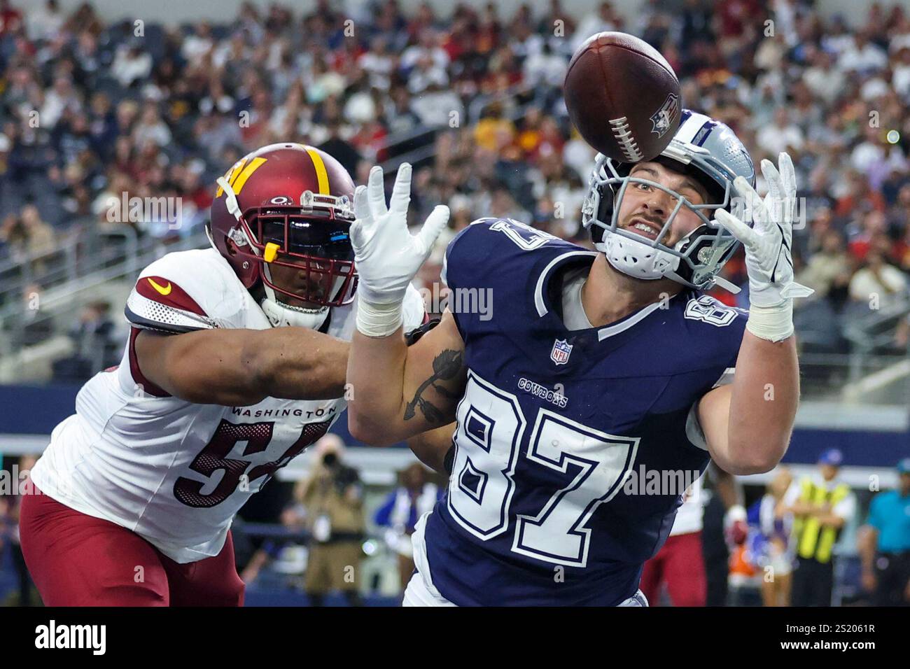 Dallas Cowboys tight end Jake Ferguson, right, tries to pull in a ...
