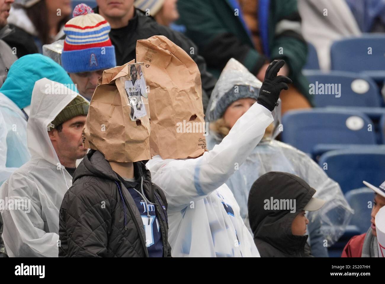 Tennessee Titans fans wear bags over their heads as they watch during ...
