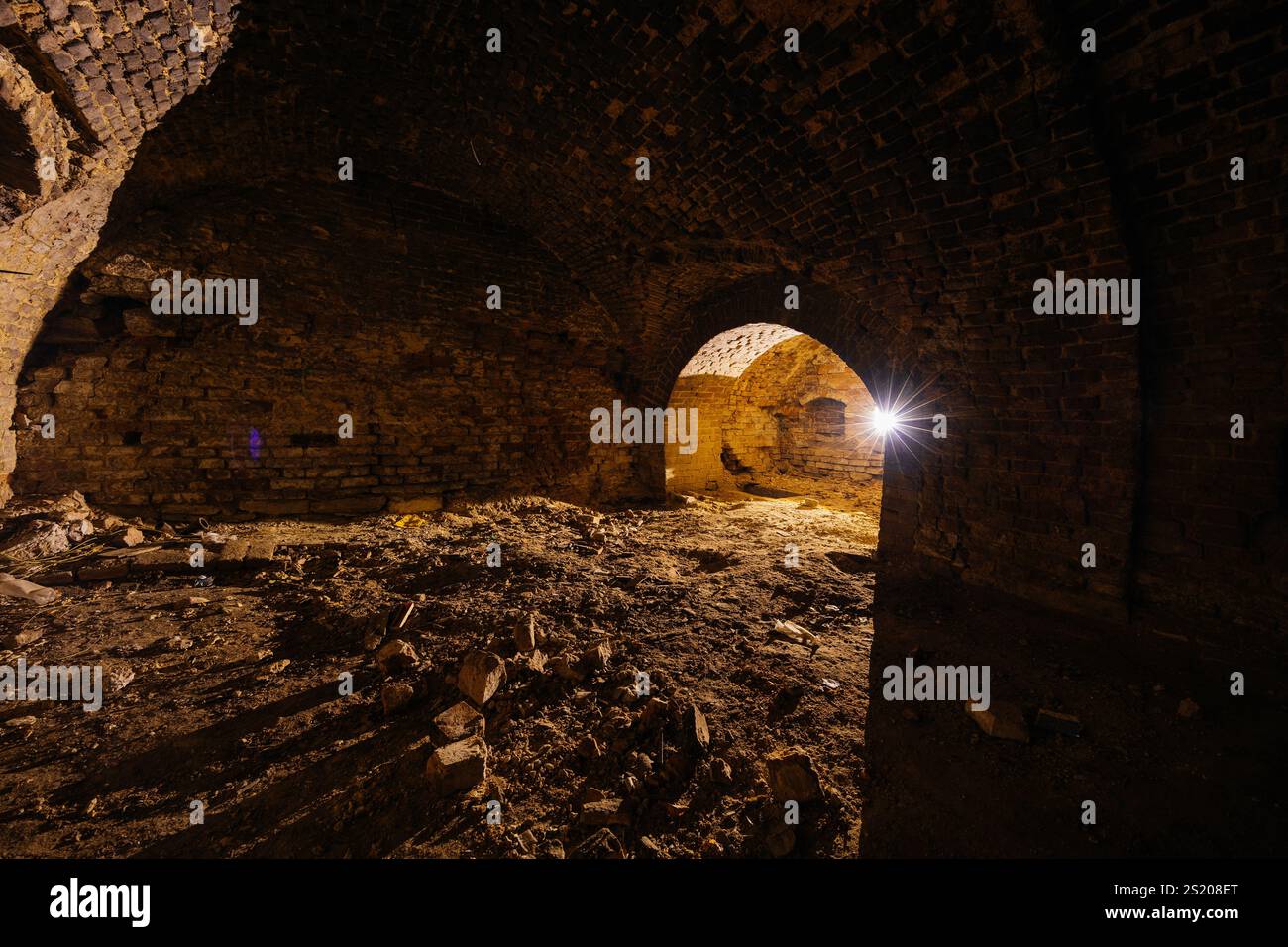 Dark and creepy vaulted red brick dungeon Stock Photo - Alamy